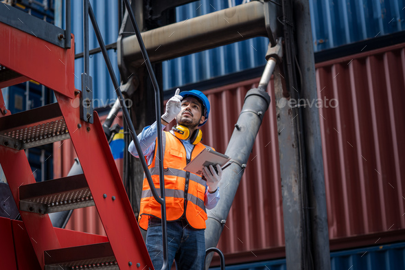 Cargo container worker checking and control loading Containers box in ...
