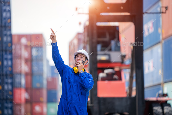 Container yard worker checking container at container yard warehouse. Stock Photo by visootu2