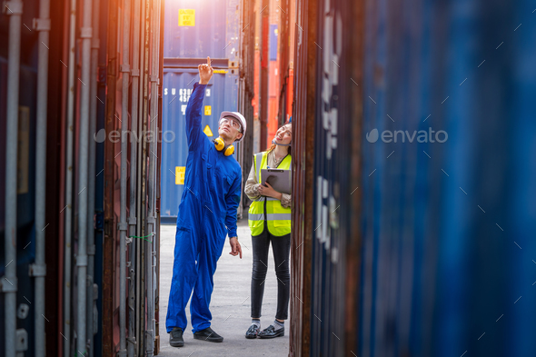 Professional container yard workers checking stock for loading in the ...