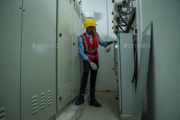 Engineer working in electrical control room,operator station network in ...