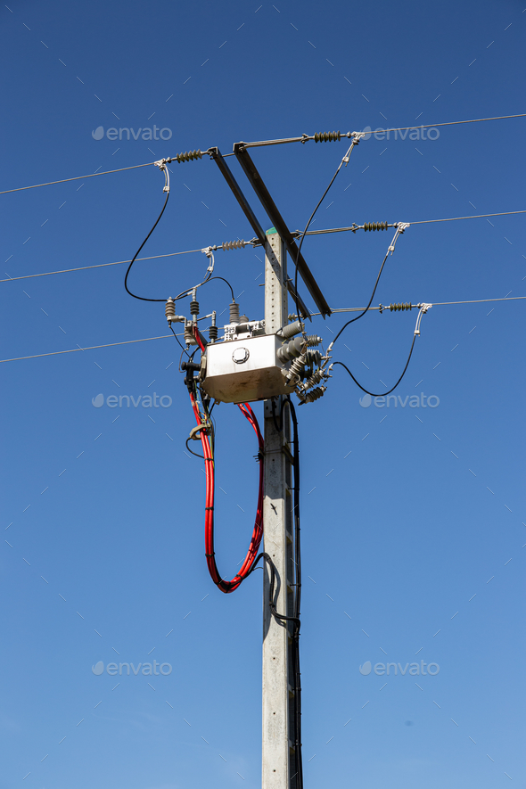 Electrical pylon with high voltage transformer on blue sky Stock Photo ...