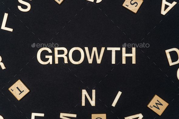GROWTH word written on dark paper background. GROWTH text for your ...