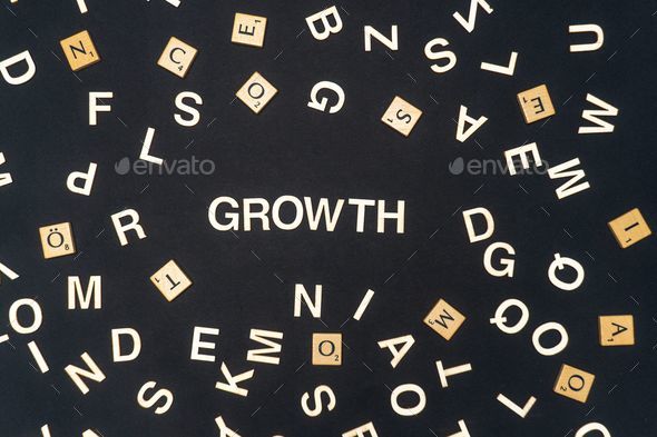 GROWTH word written on dark paper background. GROWTH text for your ...