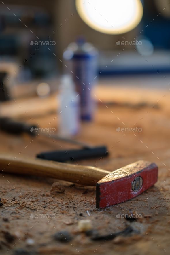 Selective of a hummer in a carpenter workshop Stock Photo by wirestock
