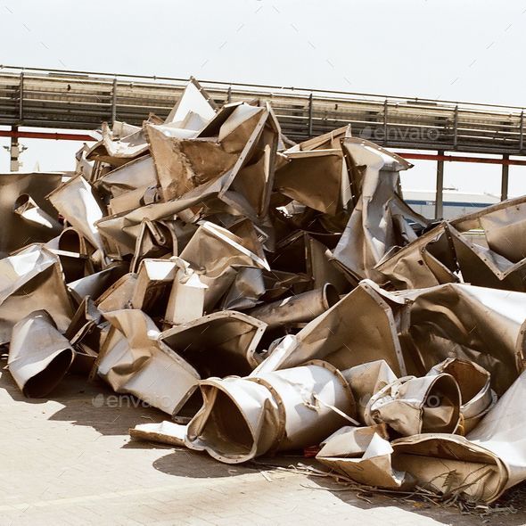 shiny scrap metal laying on the ground Stock Photo by wirestock | PhotoDune