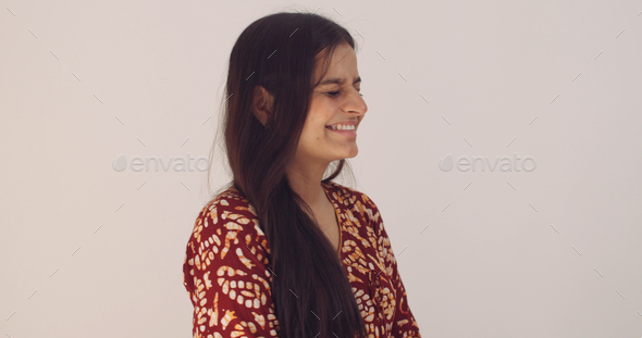 Young Indian woman with long brown hair smiling with her eyes closed ...