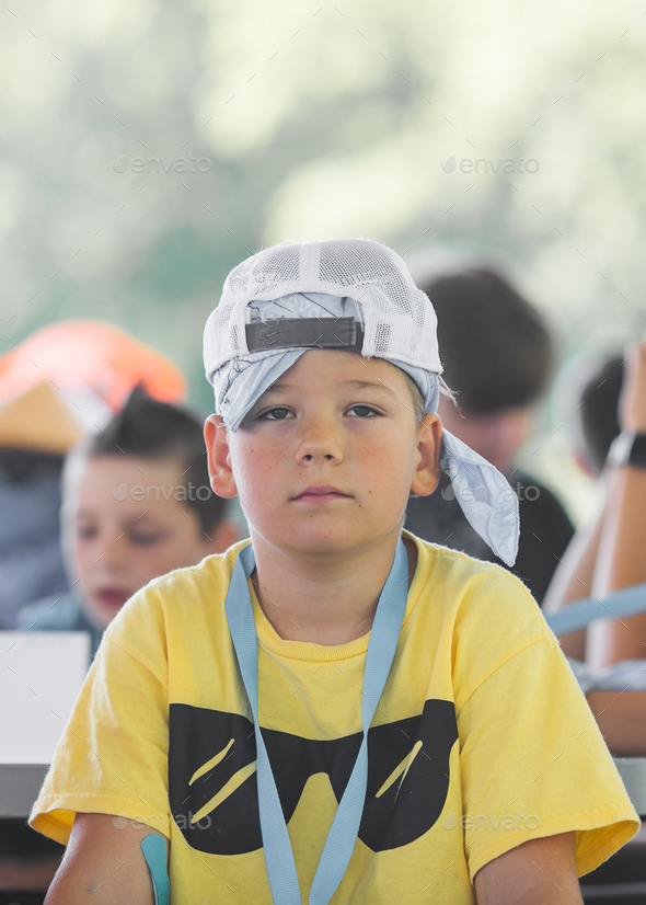 Portrait kid boy looking out with thinking face, children play on in ...