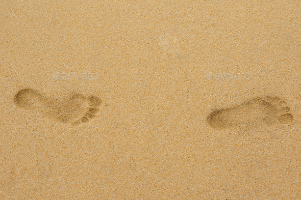 Two foot prints on the sandy sand Stock Photo by BLACKDAY | PhotoDune