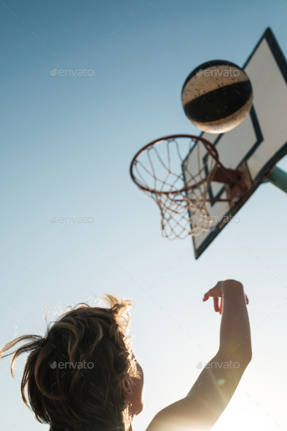 Kid throwing basketball into hoop Stock Photo by ADDICTIVE_STOCK ...