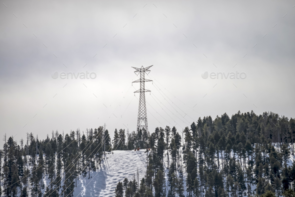 High voltage electric tower on a snowy day in the mountains Stock Photo ...
