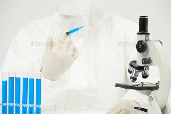 Doctor working with an optical microscope in a medical laboratory with ...