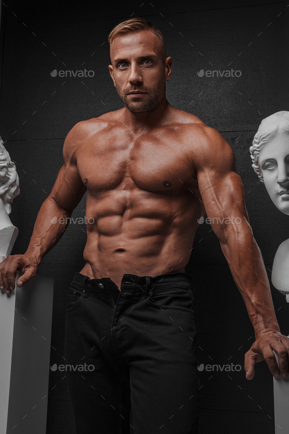 A ruggedly attractive man with a muscular physique Stock Photo by fxquadro