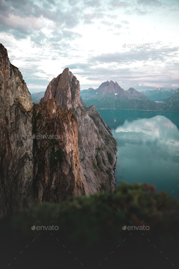 Vertical breathtaking view high mountain peak under a cloudy sky above ...
