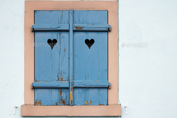 Old blue window with close shutters, hearts on shutters, blue ...
