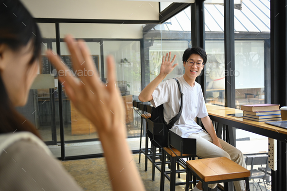 Happy college friends waving hand while greeting each other. Education ...