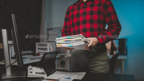 Office worker with stacks of documents, he is a startup company ...