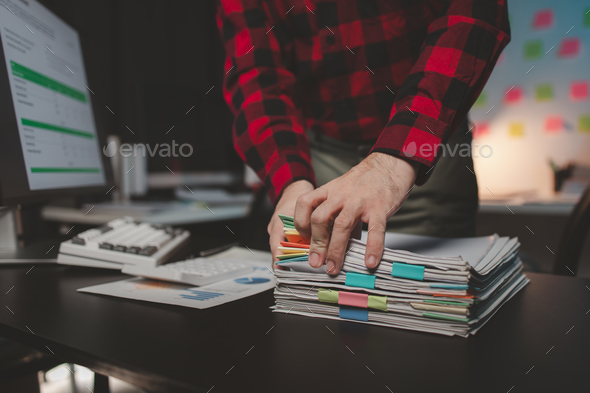 Office worker with stacks of documents, he is a startup company ...