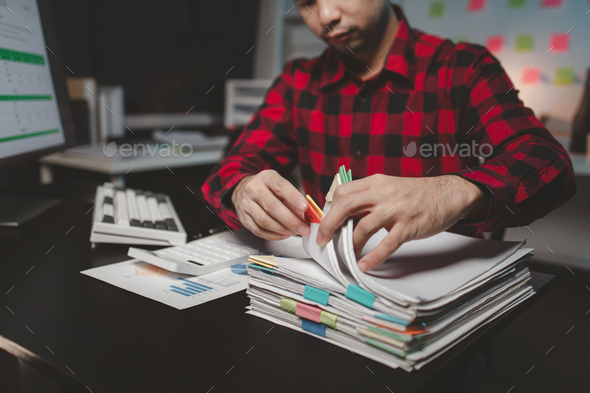 Office worker with stacks of documents, he is a startup company ...