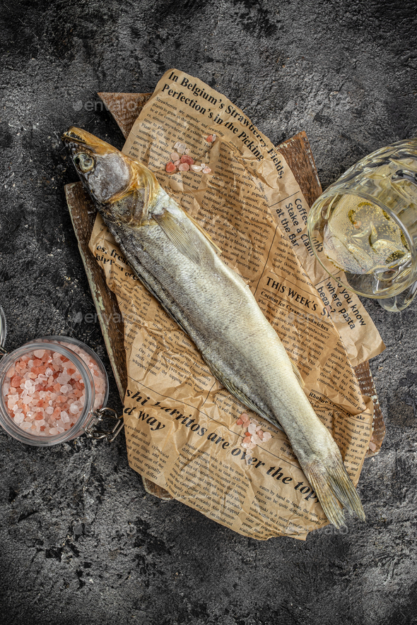 Sun dried fish, salted smelts on dark background Stock Photo by kovalnadiya