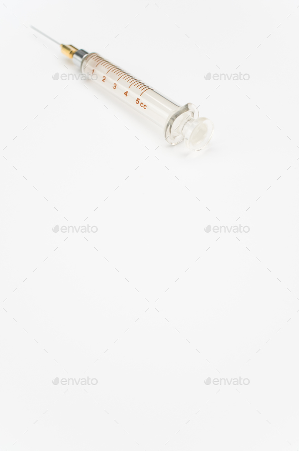 isolated sterilized glass injection syringe on a white paper background ...