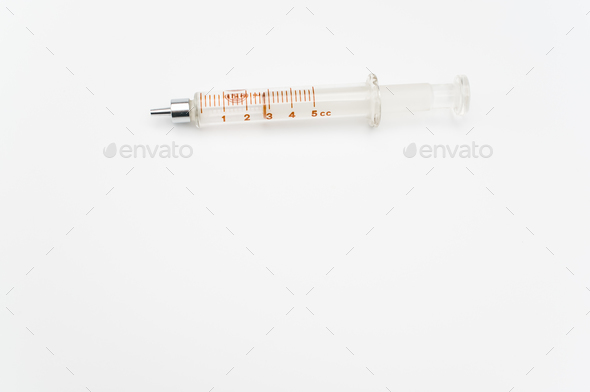 isolated sterilized glass injection syringe on a white paper background ...