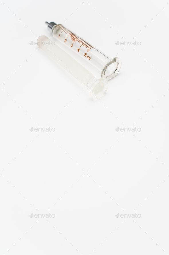isolated sterilized glass injection syringe on a white paper background ...