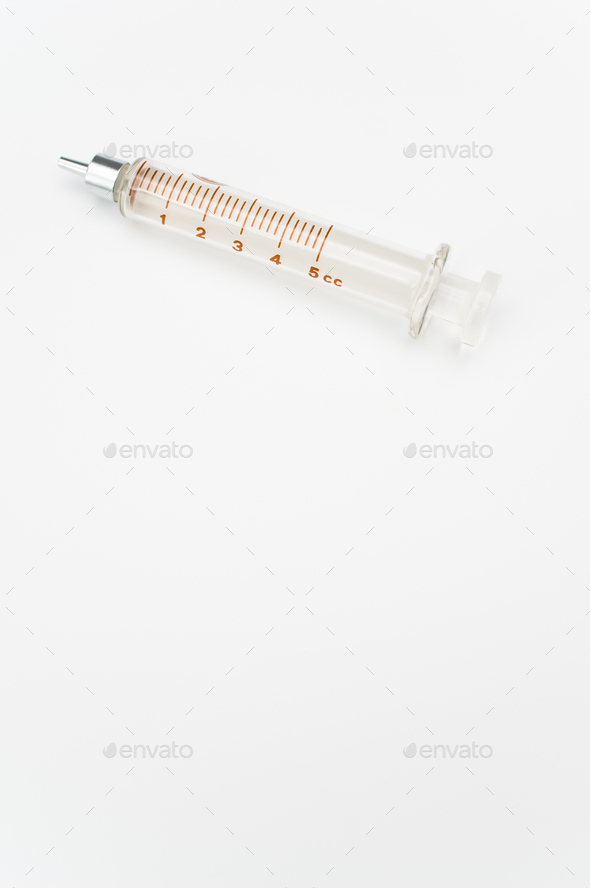 isolated sterilized glass injection syringe on a white paper background ...
