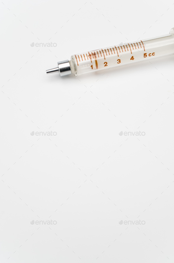 isolated sterilized glass injection syringe on a white paper background ...