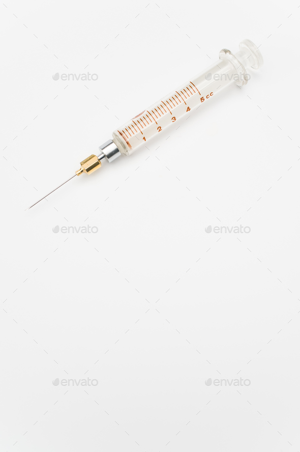 isolated sterilized glass injection syringe on a white paper background ...