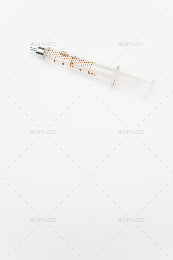 isolated sterilized glass injection syringe on a white paper background ...