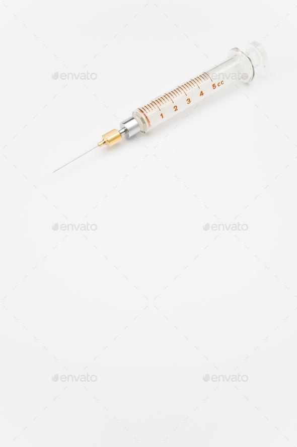 isolated sterilized glass injection syringe on a white paper background ...