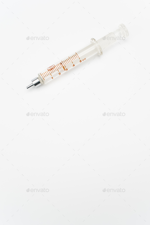 isolated sterilized glass injection syringe on a white paper background ...