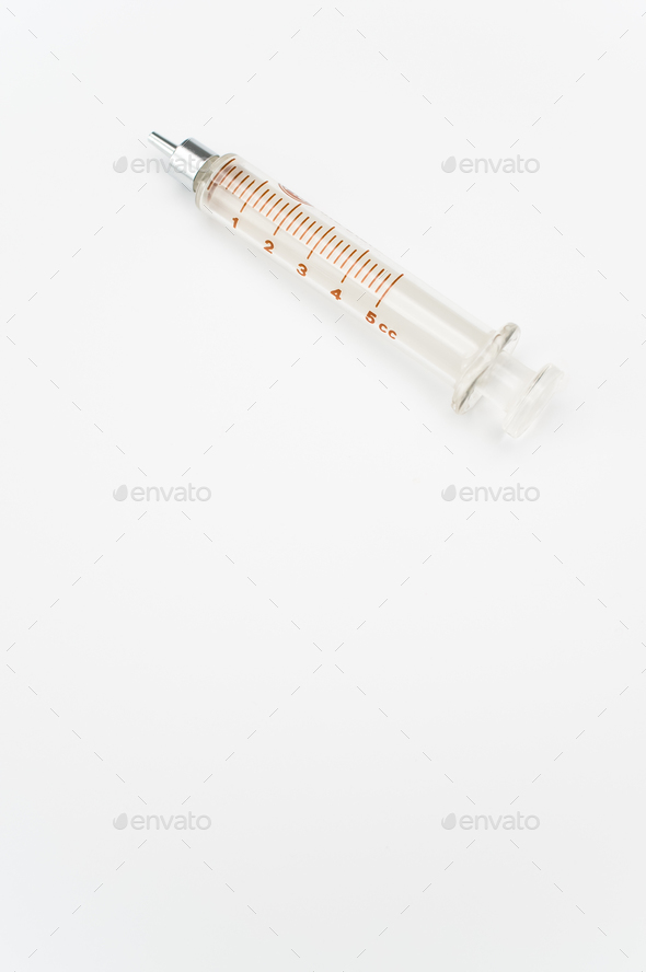 isolated sterilized glass injection syringe on a white paper background ...