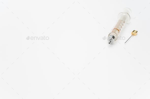 isolated sterilized glass injection syringe on a white paper background ...