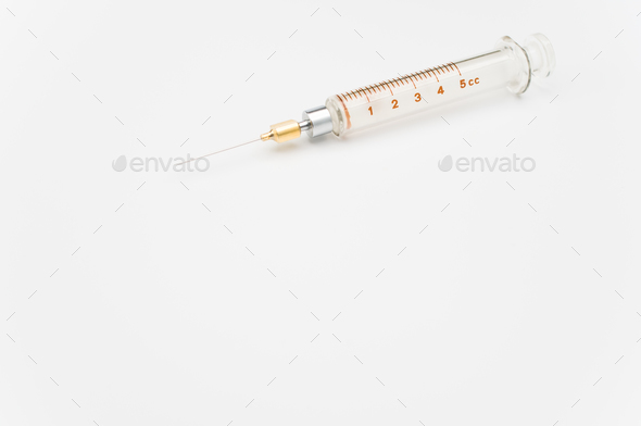 isolated sterilized glass injection syringe on a white paper background ...