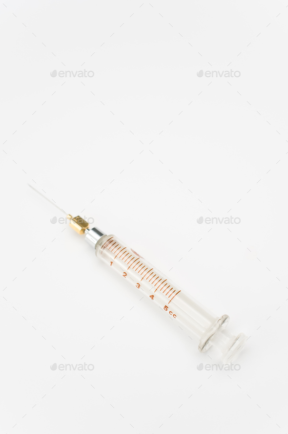 isolated sterilized glass injection syringe on a white paper background ...