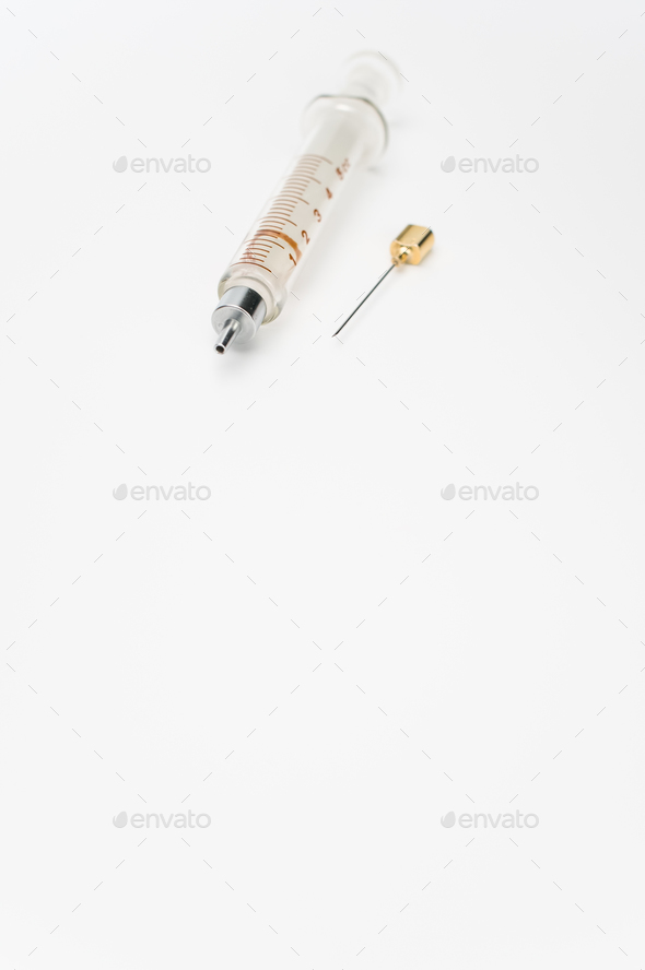isolated sterilized glass injection syringe on a white paper background ...