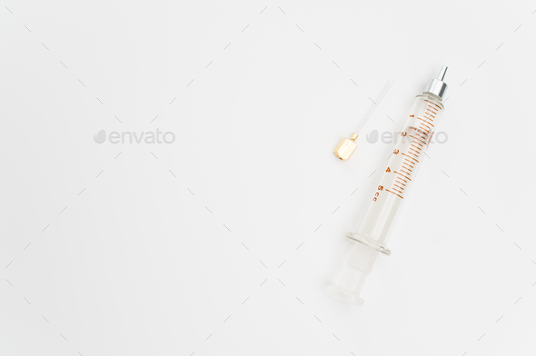 isolated sterilized glass injection syringe on a white paper background ...