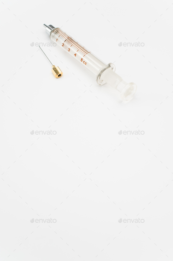 isolated sterilized glass injection syringe on a white paper background ...