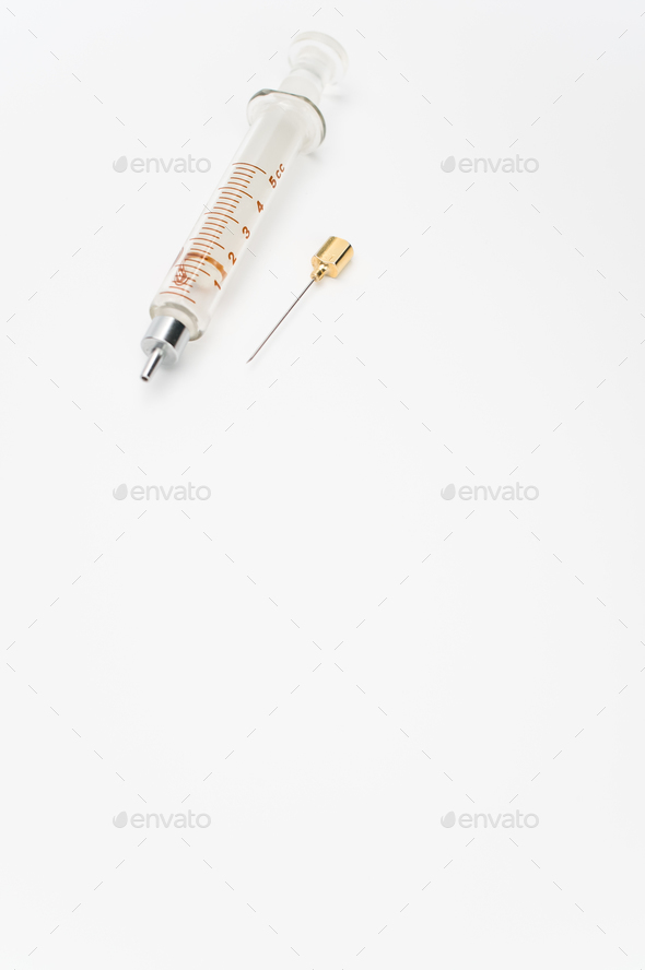 isolated sterilized glass injection syringe on a white paper background ...