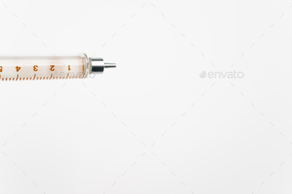 isolated sterilized glass injection syringe on a white paper background ...