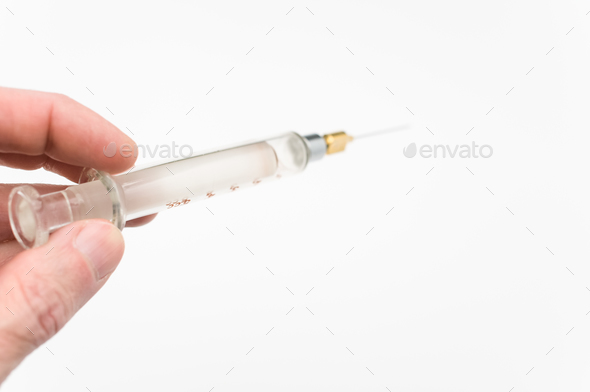 isolated sterilized glass injection syringe on a white paper background ...