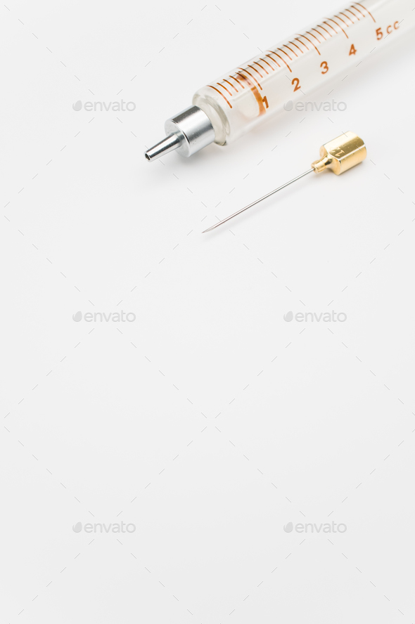 isolated sterilized glass injection syringe on a white paper background ...