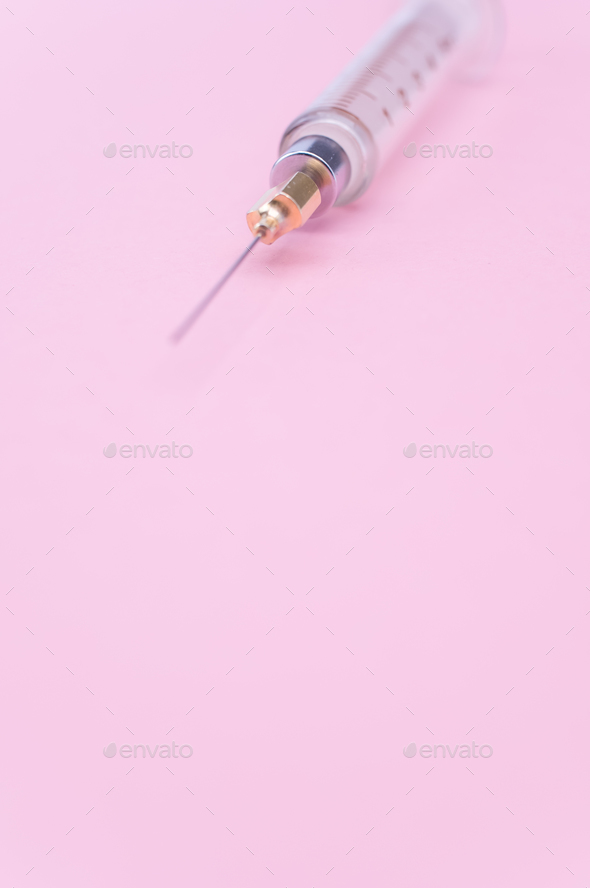 isolated sterilized glass injection syringe on a lilac paper background ...