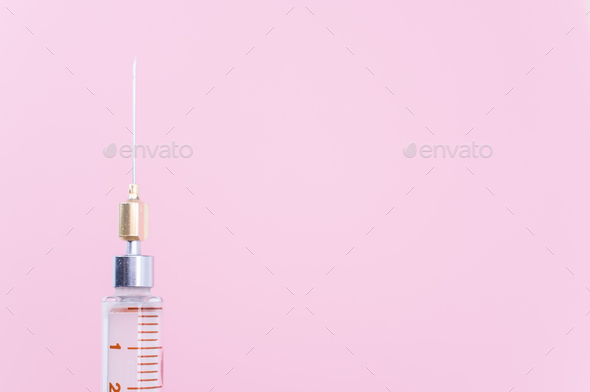 isolated sterilized glass injection syringe on a lilac paper background ...