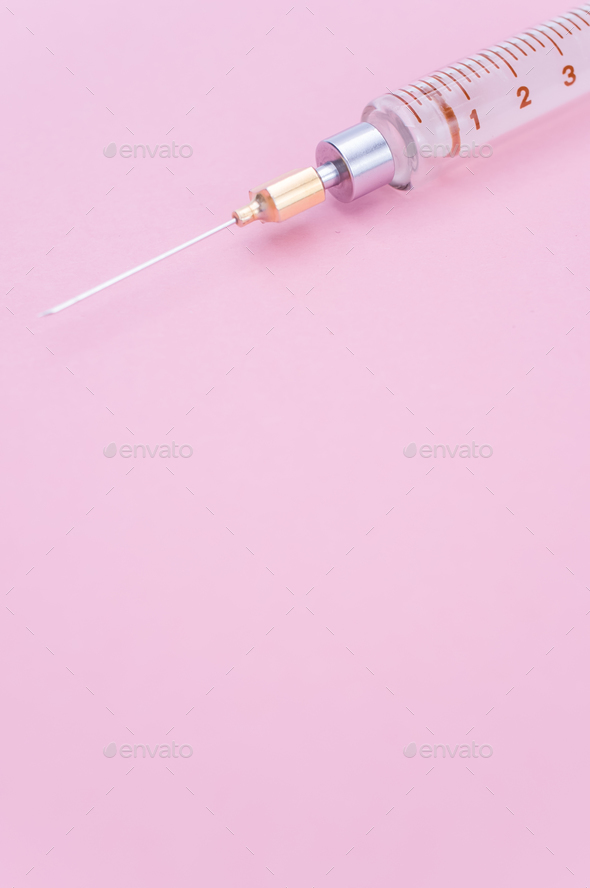 isolated sterilized glass injection syringe on a lilac paper background ...