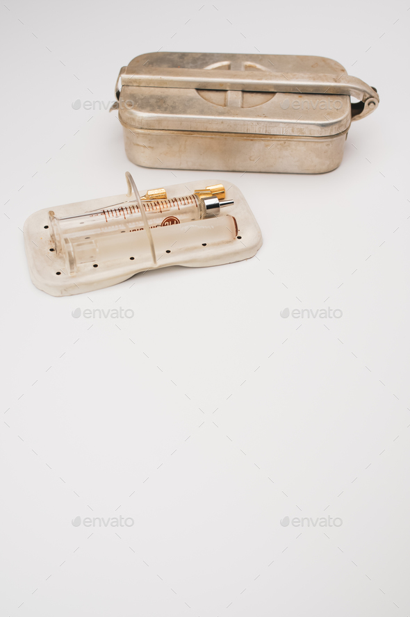 isolated sterilized glass injection syringe in a box on a white paper ...