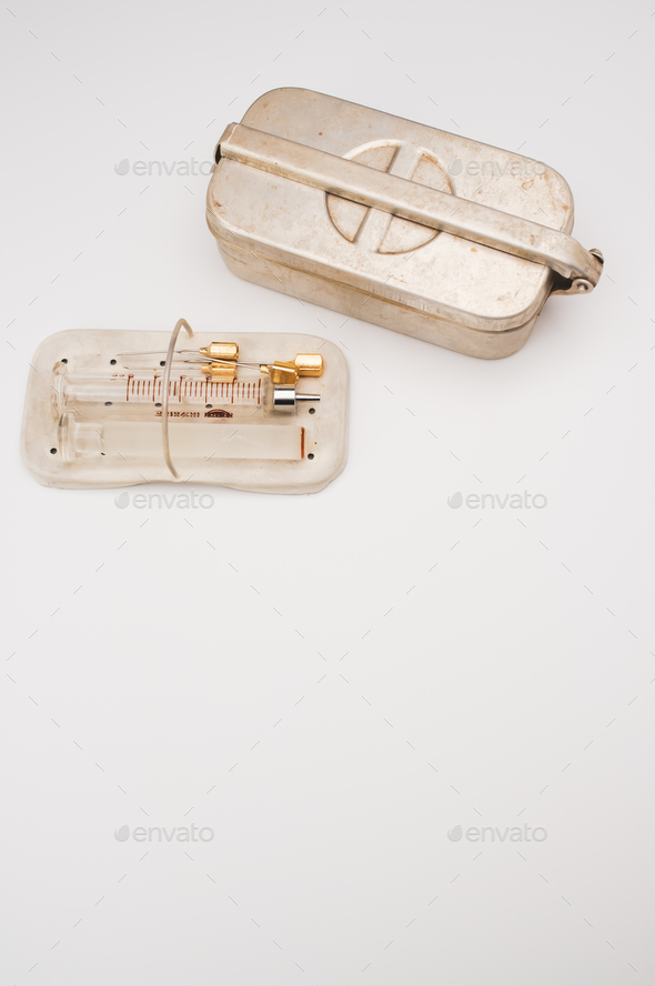 isolated sterilized glass injection syringe in a box on a white paper ...