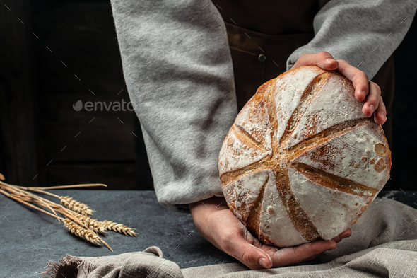Homemade sourdough bread in hands. Craft authentic bread. Home cooking ...