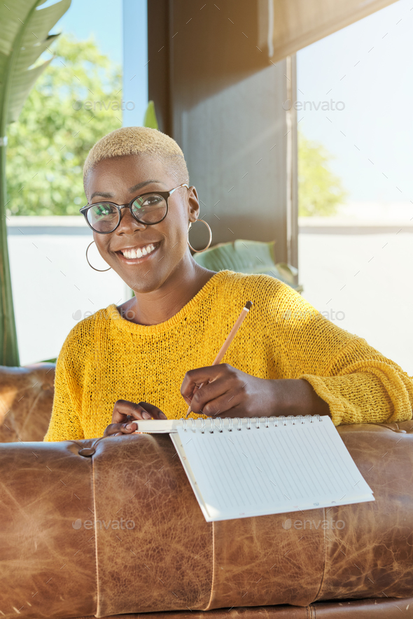 Smiling black woman writing in planner at home Stock Photo by ADDICTIVE ...